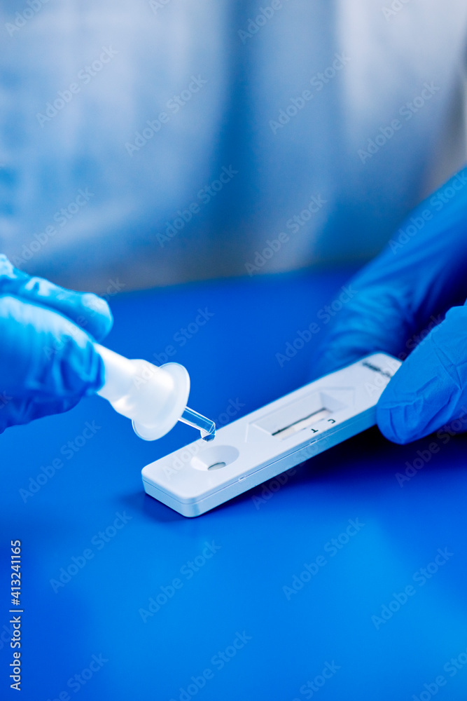 using a covid-19 rapid antigen test in the lab Stock Photo | Adobe Stock