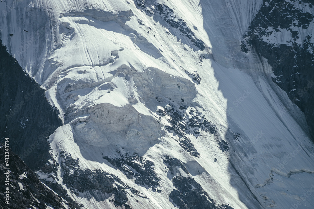 Nature background of big rocky snowy mountain wall with white glacier ...