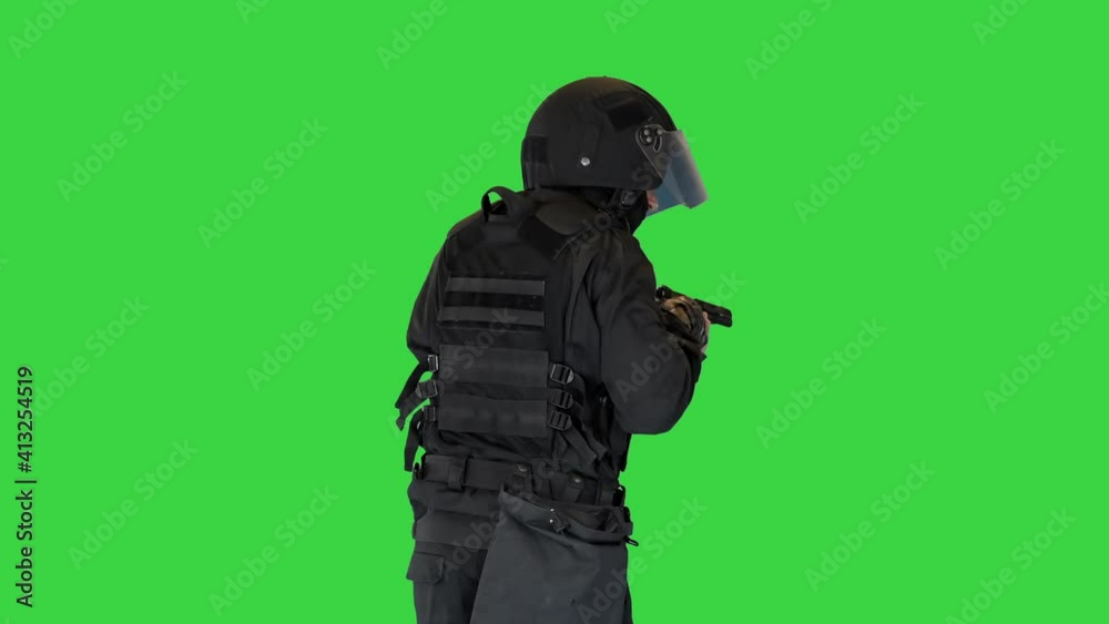 Armed Police Officer Aiming and shooting with a pistol while walking on ...