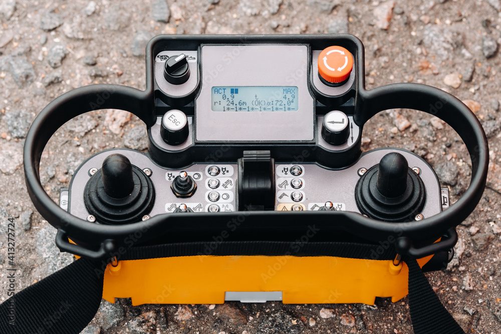 Remote control of a lifting car crane. Panel with joysticks and buttons ...