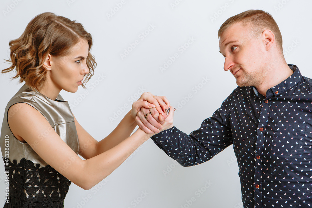 The girl wrapped her arms around the hand of the guy who clenched his ...
