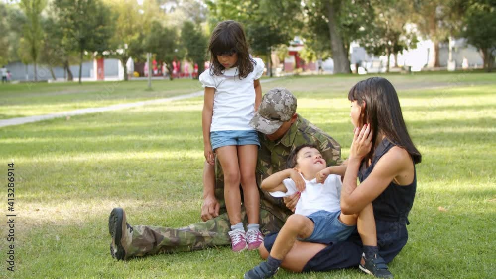 Man wearing military uniform enjoying leisure time with kids and wife ...