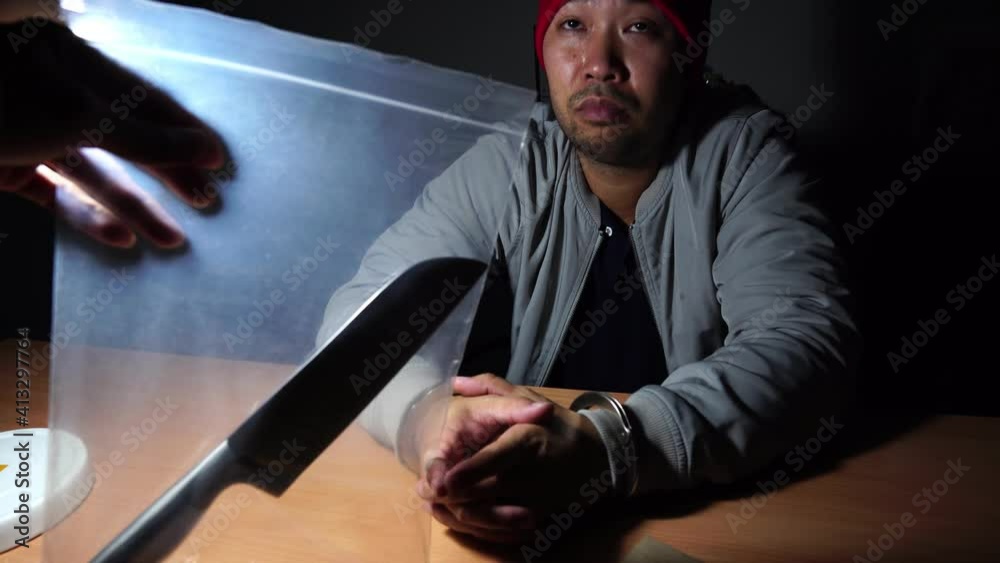 Footage 4K: Interrogator showing a knife with fingerprints as a murder ...