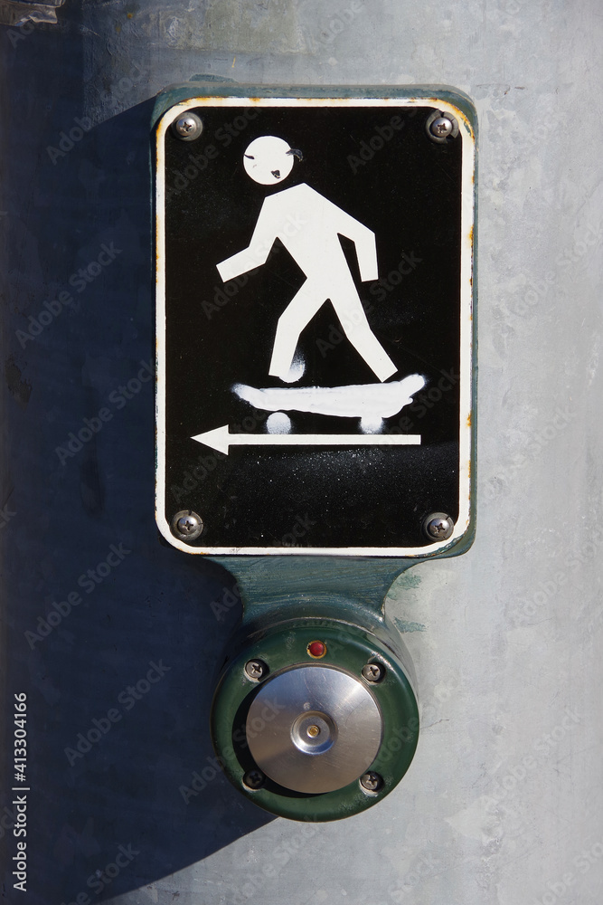 Pedestrian crosswalk push button on a traffic light with an altered ...