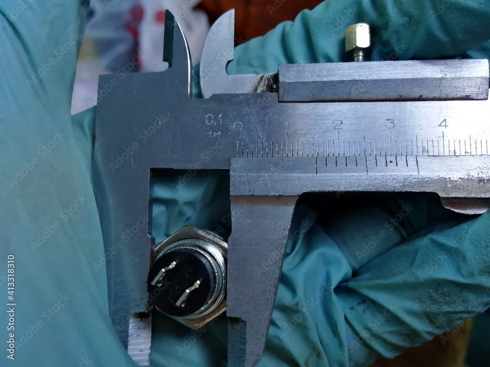 Measuring the exact diameter of the button with a caliper with a ...