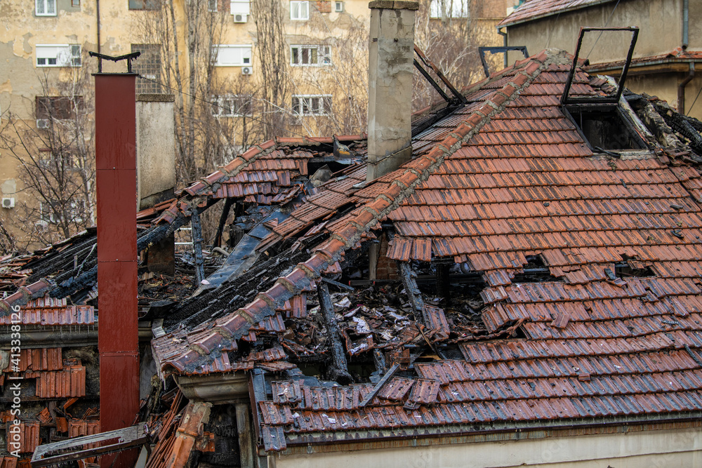 House Rooftop Fire Damage. Charred roof trusses and burnt furniture. A ...