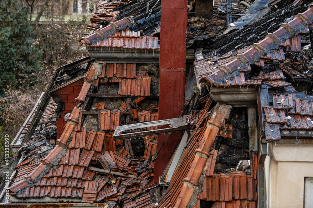 House Rooftop Fire Damage. Charred roof trusses and burnt furniture. A ...