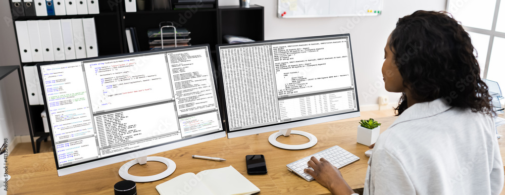 African Coder Using Multiple Computer Screens Stock Photo | Adobe Stock African Coder Using Multiple Computer Screens Stock Photo | Adobe Stock