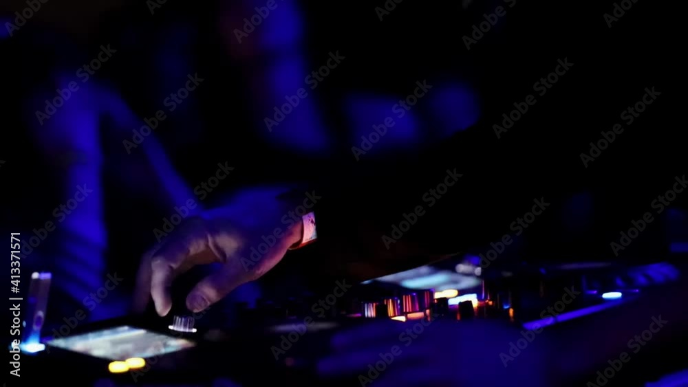DJ sound control console for mixing dance music in disco club. Hands ...