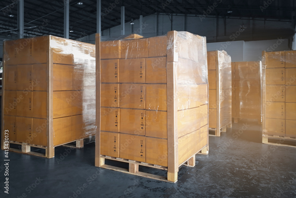 Interior of storage warehouse with stack of card board boxes wrapped ...