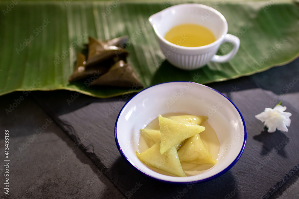 Dessert made with glutinous rice wrapped in banana leaves, triangle ...
