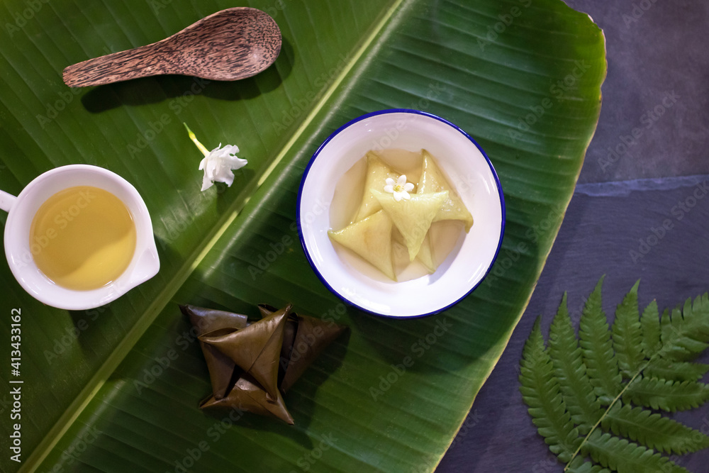 Dessert made with glutinous rice wrapped in banana leaves, triangle ...