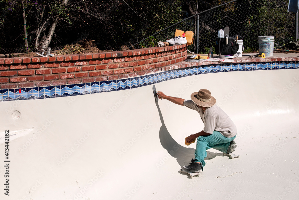 Mason smoothing plaster in a new swimming pool Stock Photo | Adobe Stock