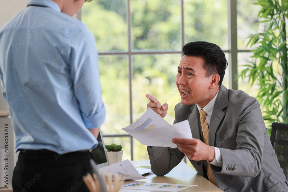Asian businessman manager in suit holding paperwork and strong talking ...