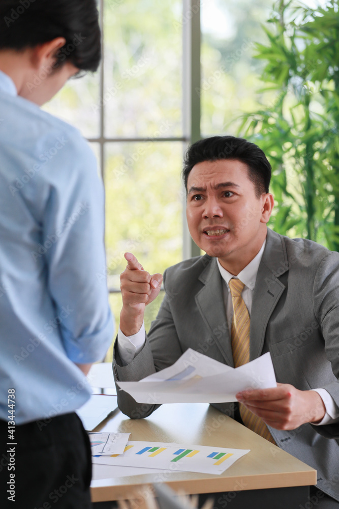 Asian businessman manager in suit holding paperwork and strong talking ...