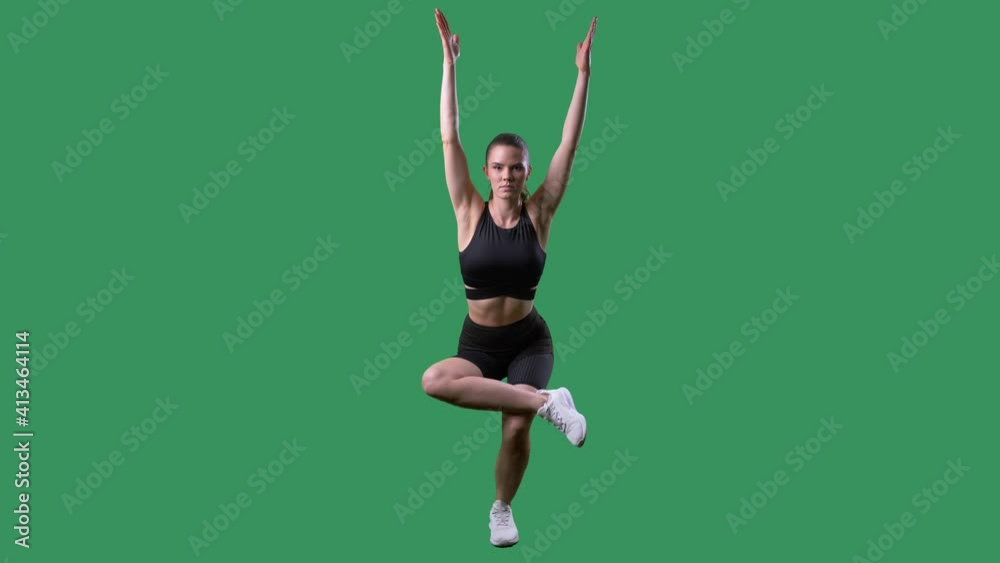 Fit woman exercises single leg squat figure four pose with outstretched ...