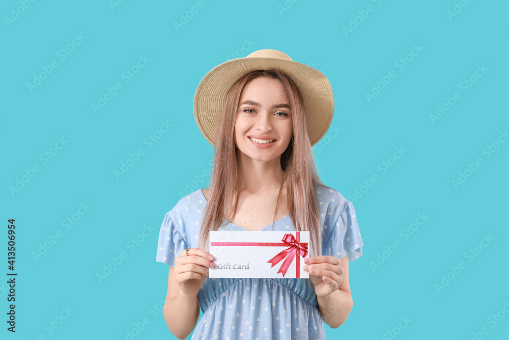 Beautiful young woman with gift card on color background Stock Photo ...