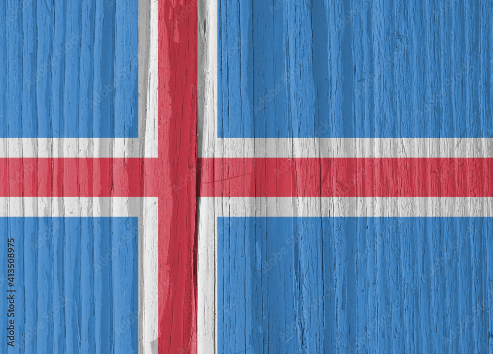 The flag of Iceland on dry wooden surface, cracked with age. Light pale ...