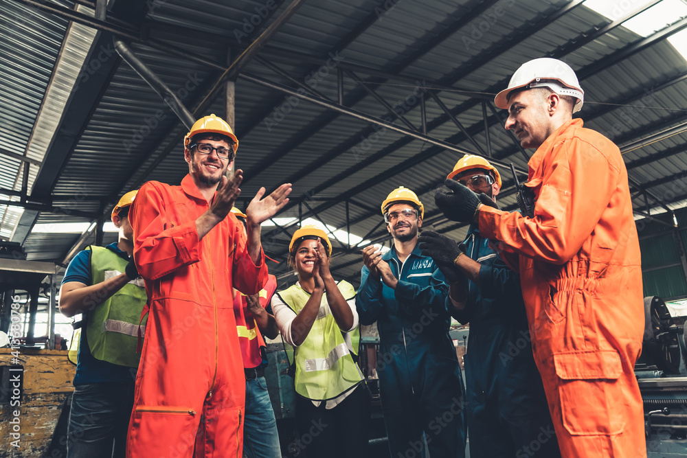 Skillful worker celebrate success in the factory . Industrial people ...