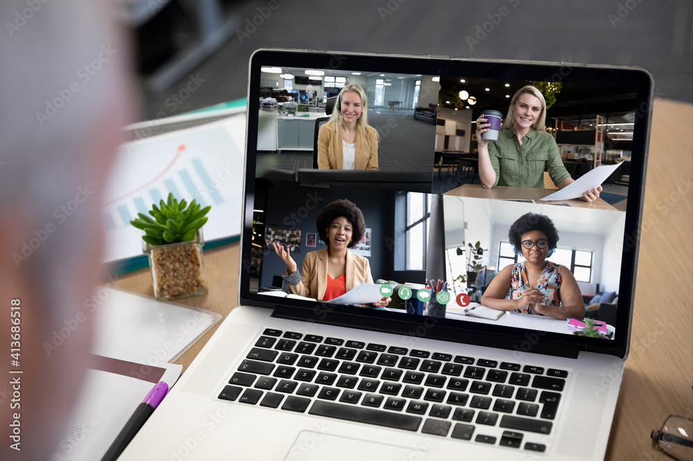 Diverse businesswomen displayed on laptop screen during office video ...
