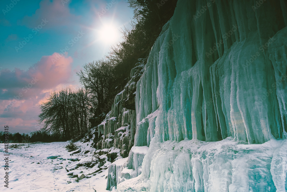 Frozen and icy streams filled with cold spring water flowing through ...