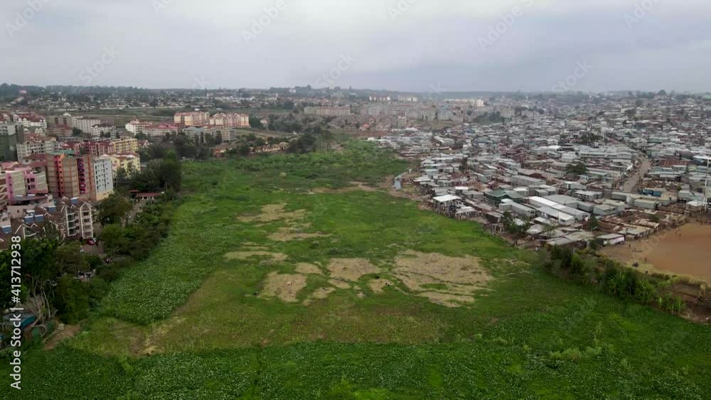 Drone ascending over the green farm in slums of Nairobi, slums of ...