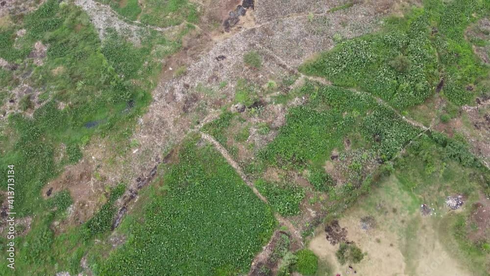 Kibera slums of Nairobi Kenya, drone passing over the green farm in the ...