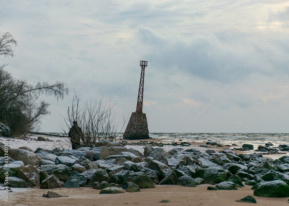 Foto de in the background the ruins of an old lighthouse, a sandy beach ...