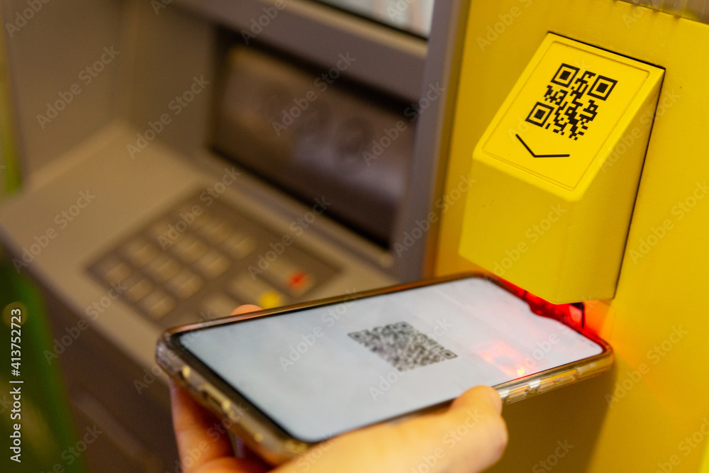 Contactless use of an ATM, reading a QR code from a smartphone, Stock ...