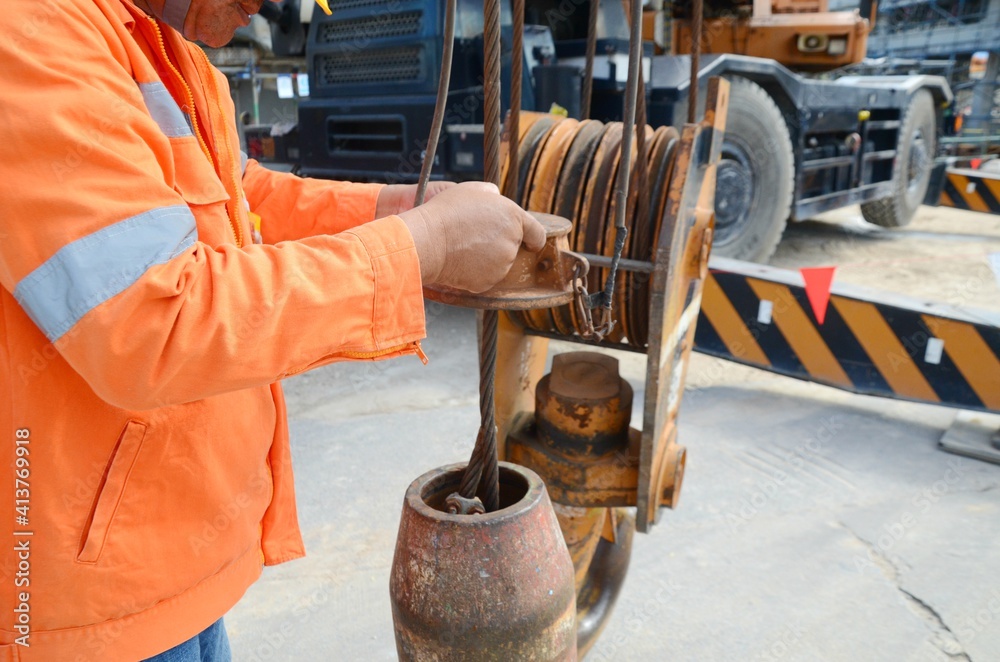 Crane operator conducting safety inspecting on the wire sling which ...