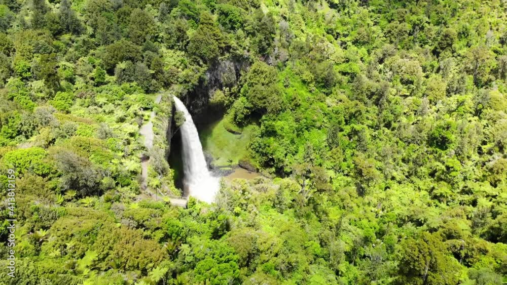 55 metres waterfall aerial fly over rainforest tilt down to the lagoon ...