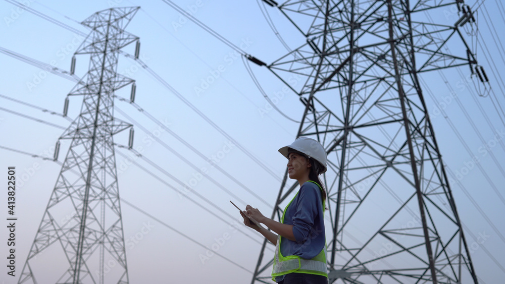 Female electrical engineer working near to High voltage tower. Stock ...