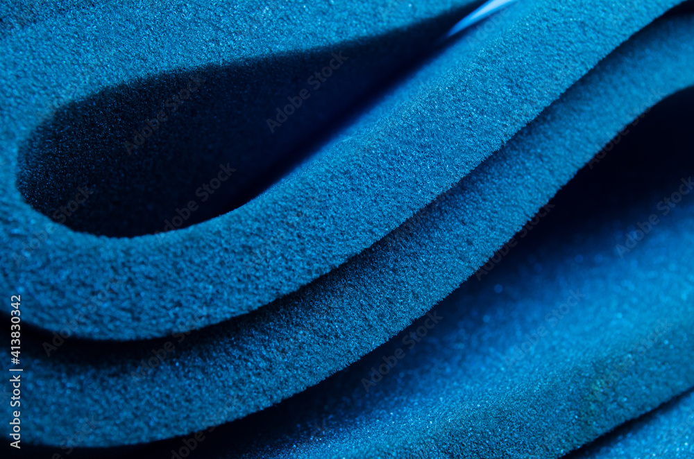 rolled up in a curved bright blue foam sponge. folded foam sponge ...