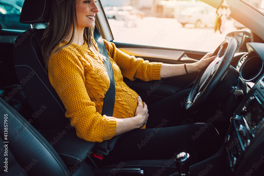 Beautiful pregnant happy woman driving car. Stock Photo | Adobe Stock
