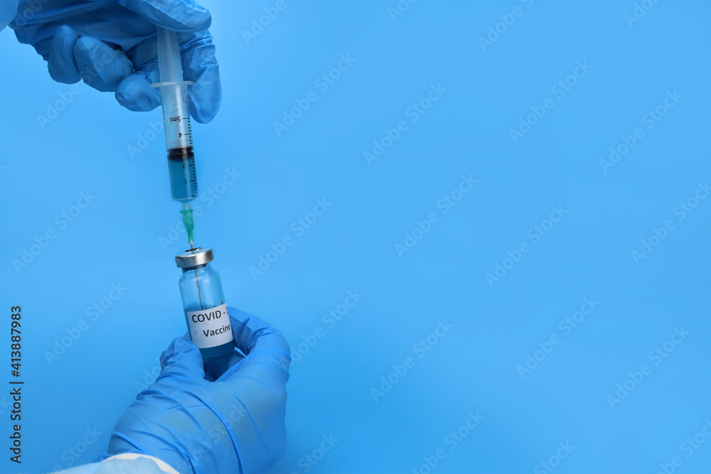 ampoule with coronavirus vaccine covid 19 and a syringe for injections ...