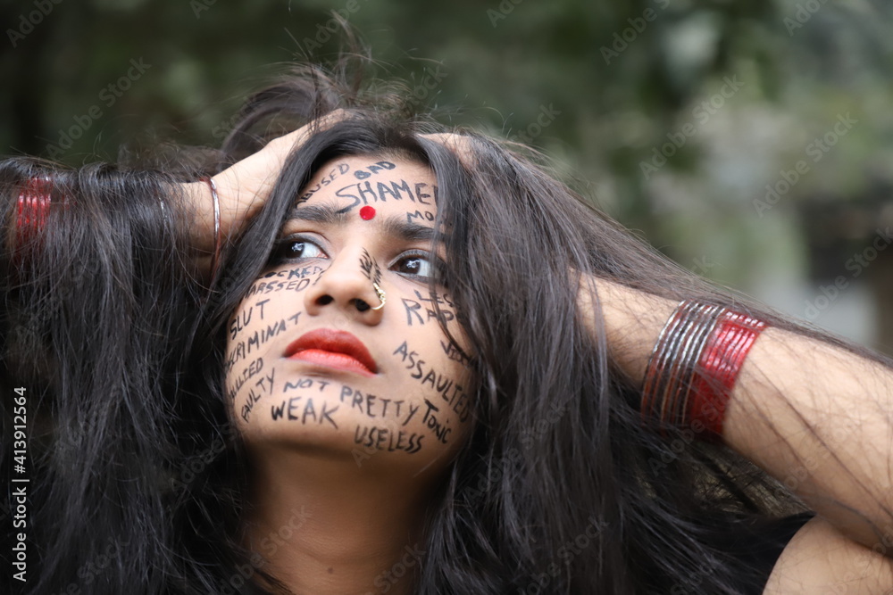 Foto de A southeast Asian brown woman protesting gender based violence ...