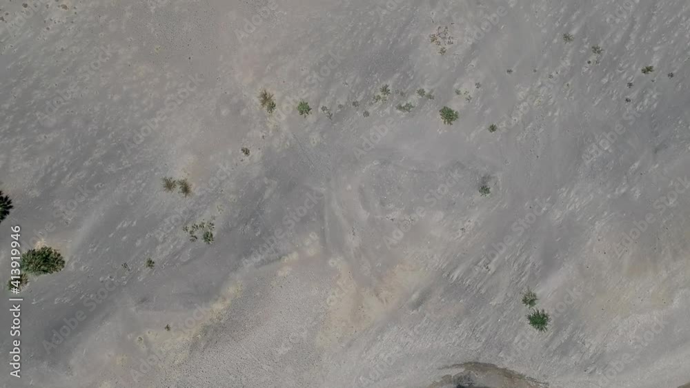 Lake Turkana shoreline with small waves lapping and sandy shore and ...