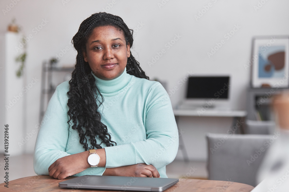 Front view portrait of curvy African-American woman looking at camera ...