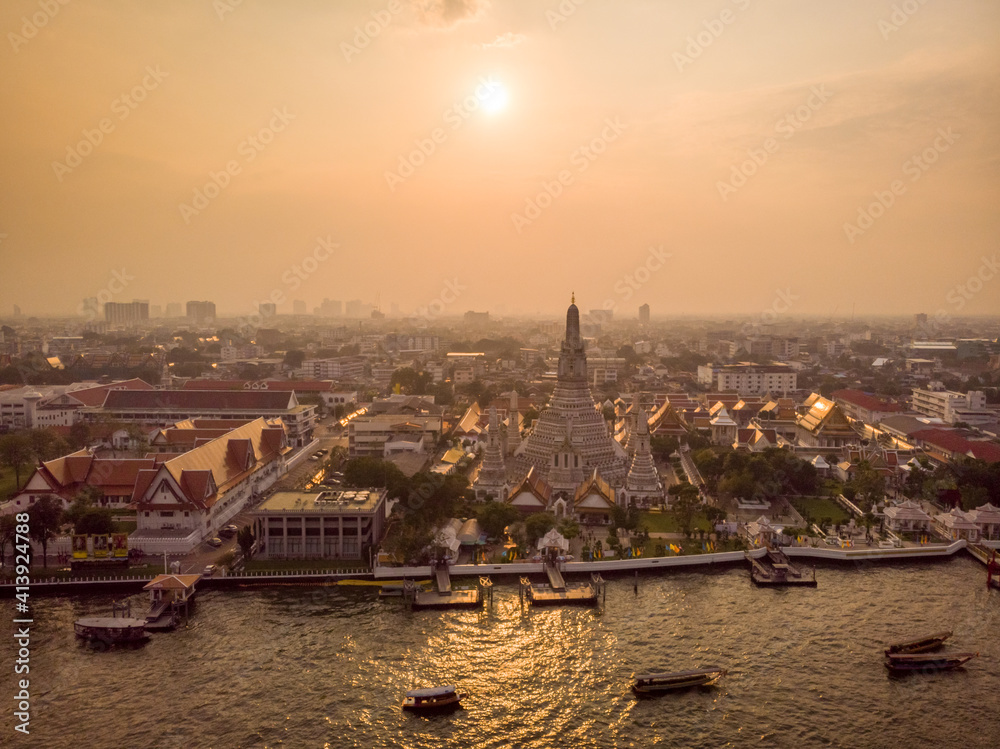 Aerial view of Wat Arun Pagoda along the Chao Phraya river at sunset ...