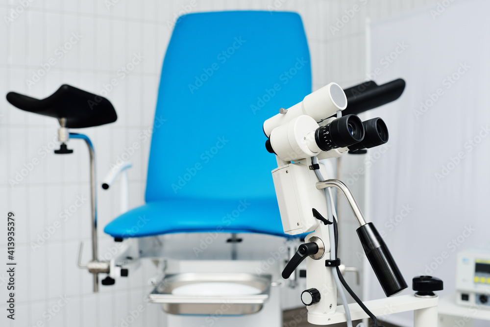 blue gynecological chair and colposcope close-up in a modern clinic ...