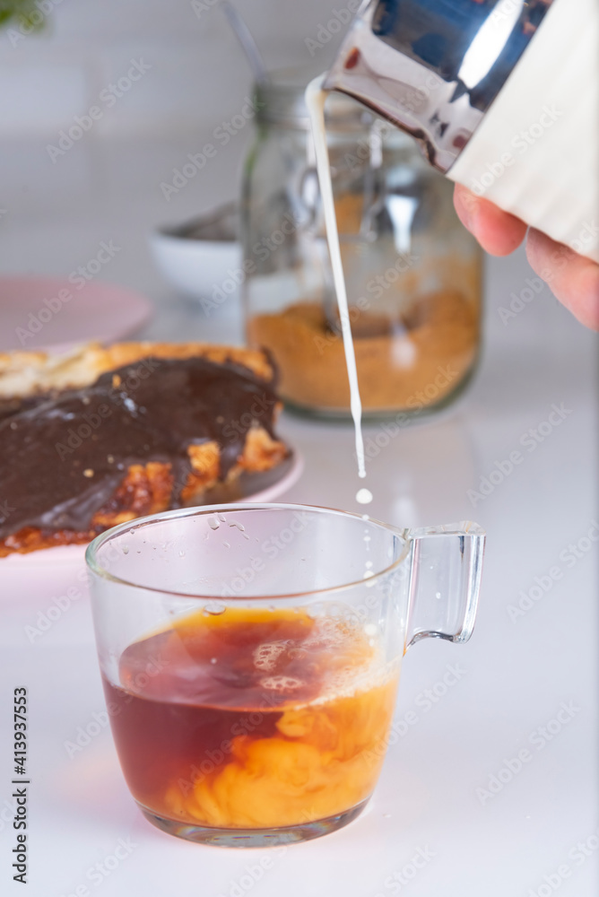 Cup of Tea falling splash of milk, on white background with chocolate ...