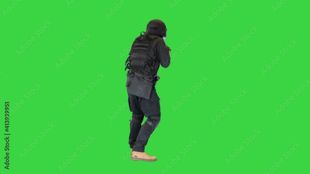 Police special forces officer holding position on a Green Screen ...