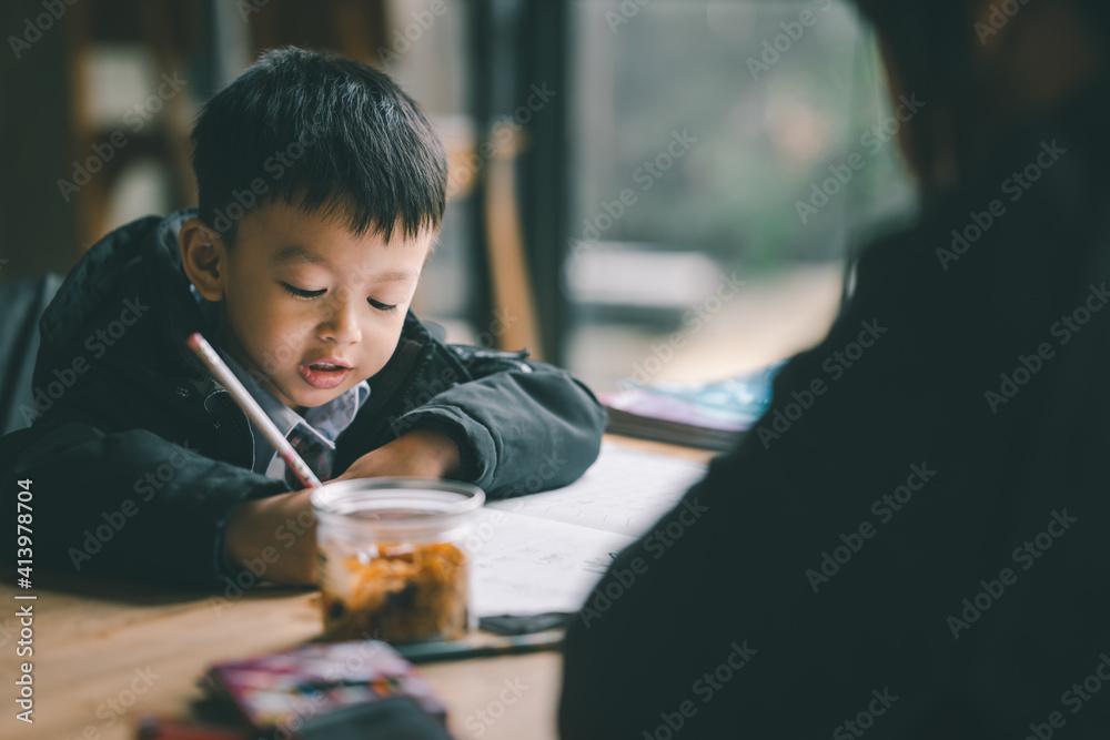 Asian Boy Doing homework with the intention And have a mother to ...