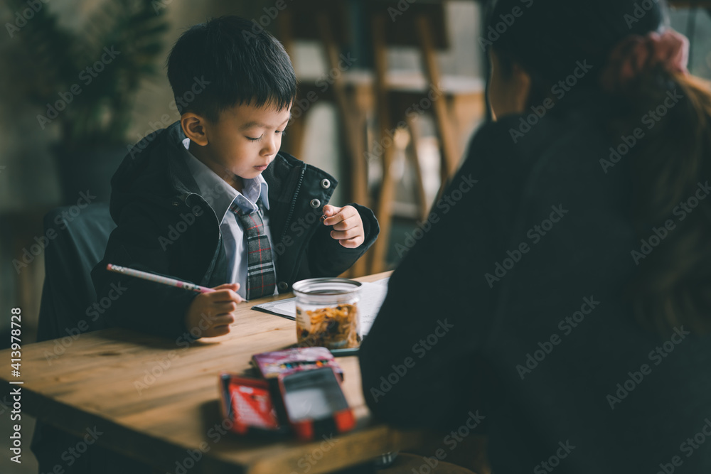 Asian Boy Doing homework with the intention And have a mother to ...