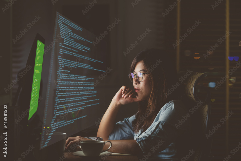 Asian Businesswoman working hard with front of computer desktop with ...