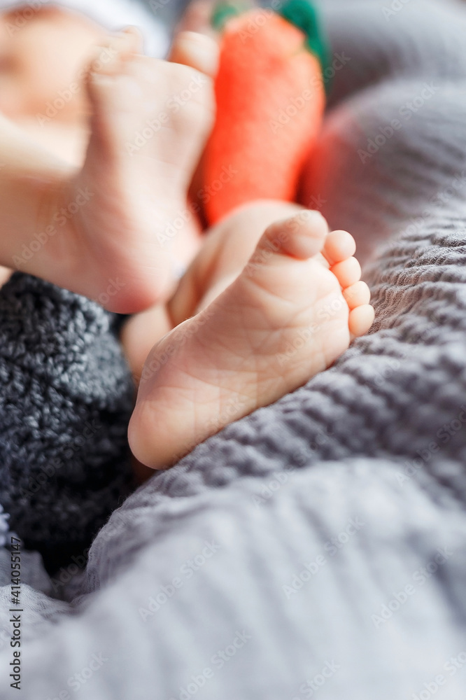 Blurred close up of newborn baby's feet. Baby's tiny little toes on the ...