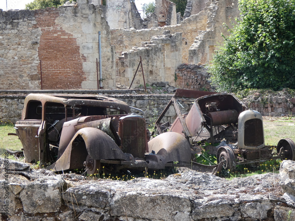Fotka „Two rusting cars in the war torn ruins of Oradour-sur-Glane in ...