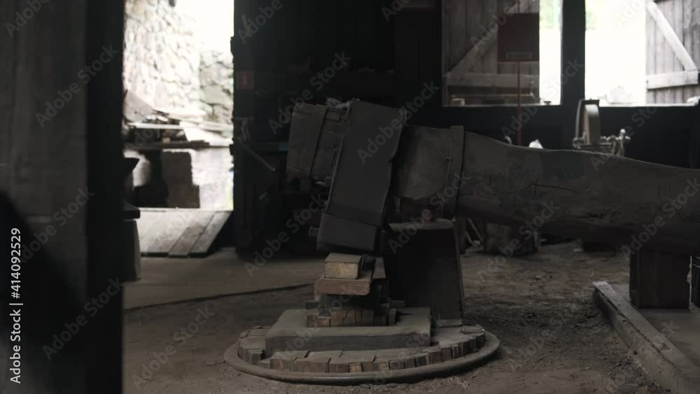 Antique water hammer in traditional blacksmith shop. Historical water ...