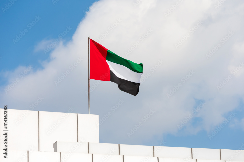UAE flag waving in the sky, national symbol of UAE. UAE National Day ...
