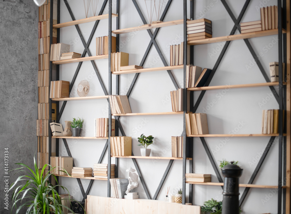 Home library on open shelves in a trendy, stylish loft-style bedroom ...